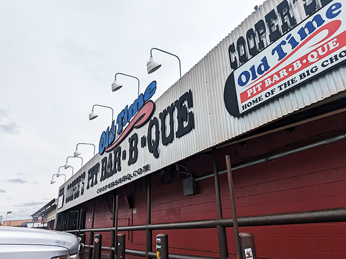 Welcome to meat paradise! Cooper's Old Time Pit Bar-B-Que stands proud, its red-trimmed exterior promising smoky delights that'll make your taste buds do a happy dance.