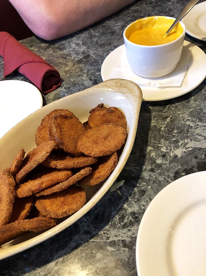 Spud-tacular! These crispy potatoes with gooey cheese sauce are what comfort food dreams are made of.