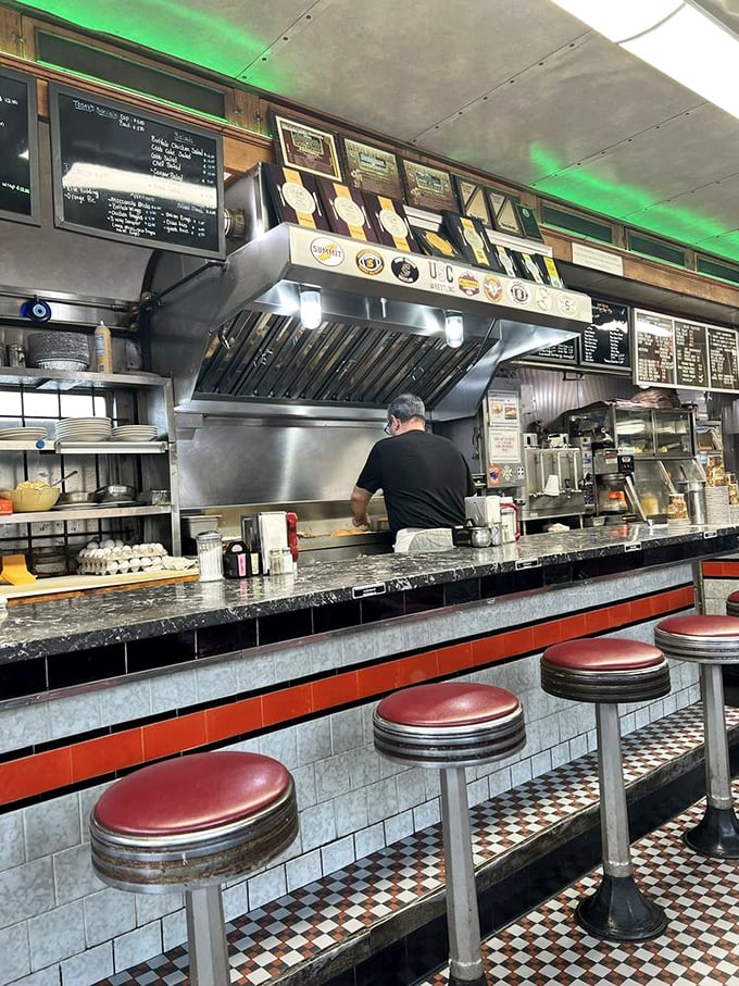 The counter – where strangers become neighbors and the cook's rhythmic spatula work provides the soundtrack to your morning ritual.