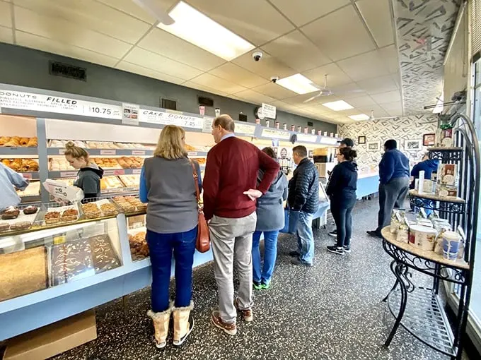 The line of anticipation! These patient customers know that good things come to those who wait – especially when those good things are freshly made donuts.