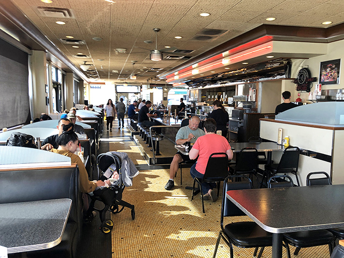 A slice of Anchorage life, served hot and fresh. These diners aren't just eating – they're participating in a time-honored ritual of community and comfort.
