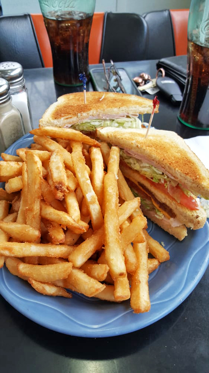 The classic diner duo: a sandwich that requires a jaw workout and fries so crispy they could wake the dead.