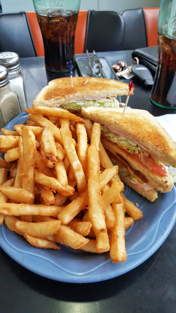 The classic diner duo: a sandwich that requires a jaw workout and fries so crispy they could wake the dead.