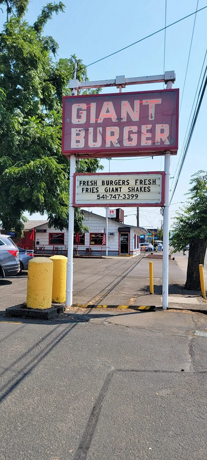 The beacon of burger bliss! This sign is like a lighthouse, guiding hungry souls to safe, delicious harbor.