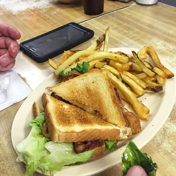 The classic BLT, elevated to art form. Crispy bacon, fresh lettuce, and juicy tomatoes nestled between golden toast, with a side of crispy fries for good measure.