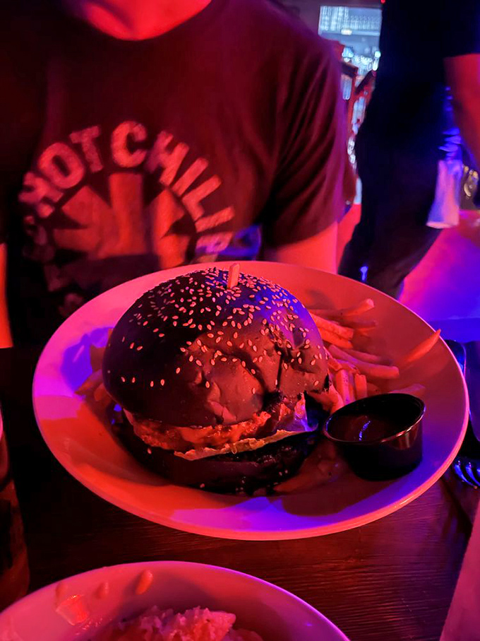 Darth Vader called – he wants his burger back! This imposing black bun creation is a force to be reckoned with. May the flavor be with you!
