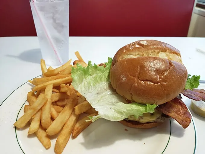 This isn't just a burger—it's architecture. A perfectly constructed tower of beef, bun, and fixings with fries standing guard.