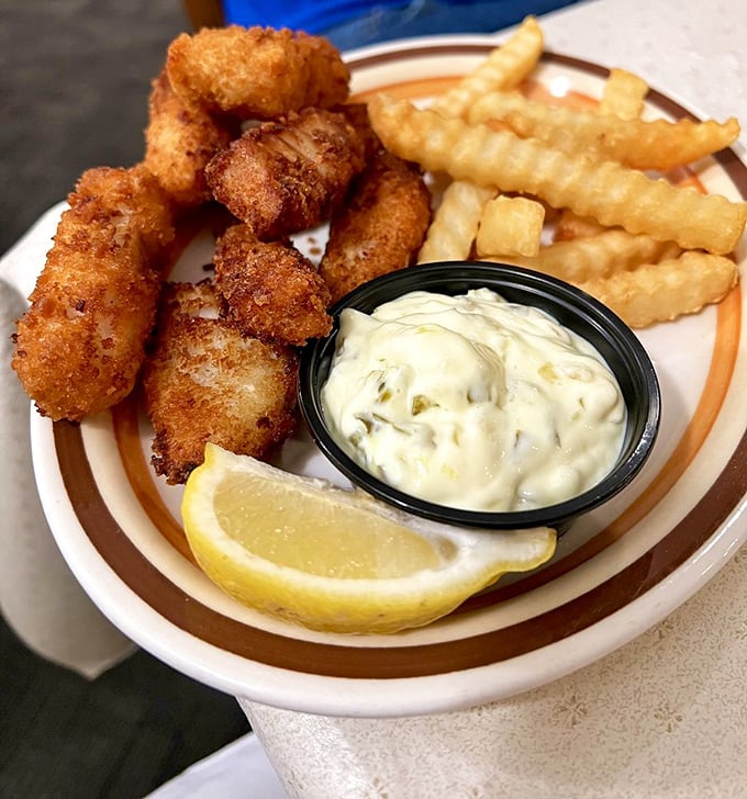 Golden-fried walleye bites with that perfect crunch-to-tenderness ratio. The tartar sauce isn't just a condiment—it's a perfect partner.