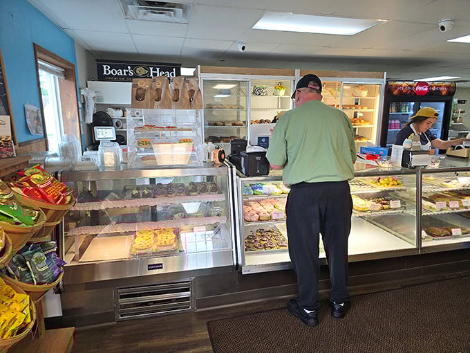 Behind this counter, dreams come true. It's like a treasure chest, but instead of gold, it's filled with glazed, sprinkled, and cream-filled riches.