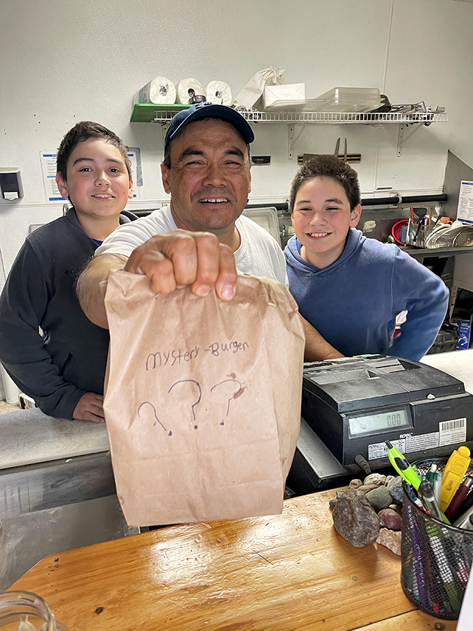 The secret ingredient? Smiles! This cheerful crew is serving up mystery burgers with a side of Alaskan hospitality.