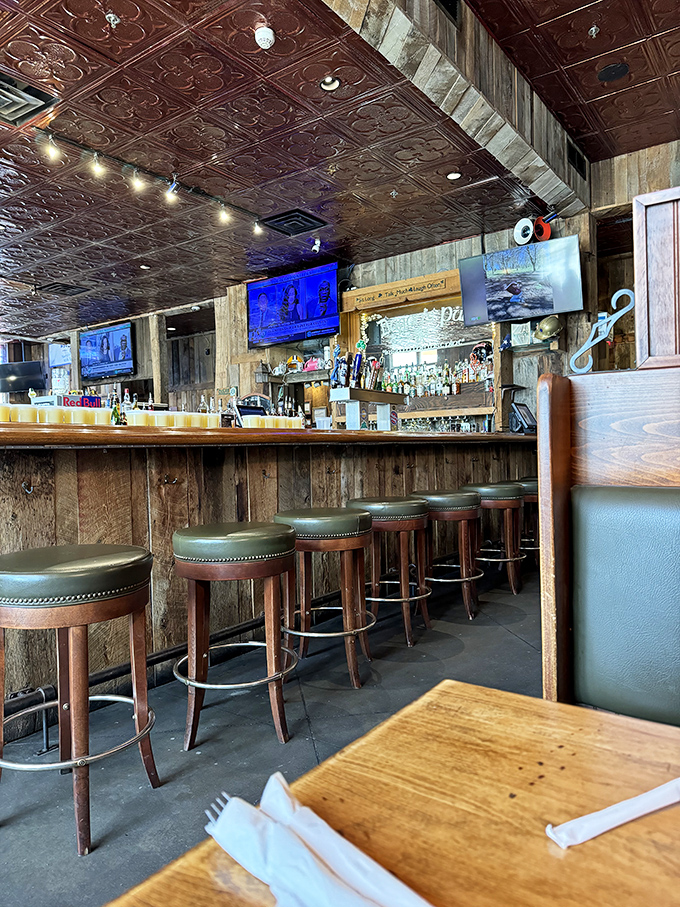 At this bar, stories flow as freely as the perfectly poured pints, under the watchful gaze of that glorious pressed tin ceiling.