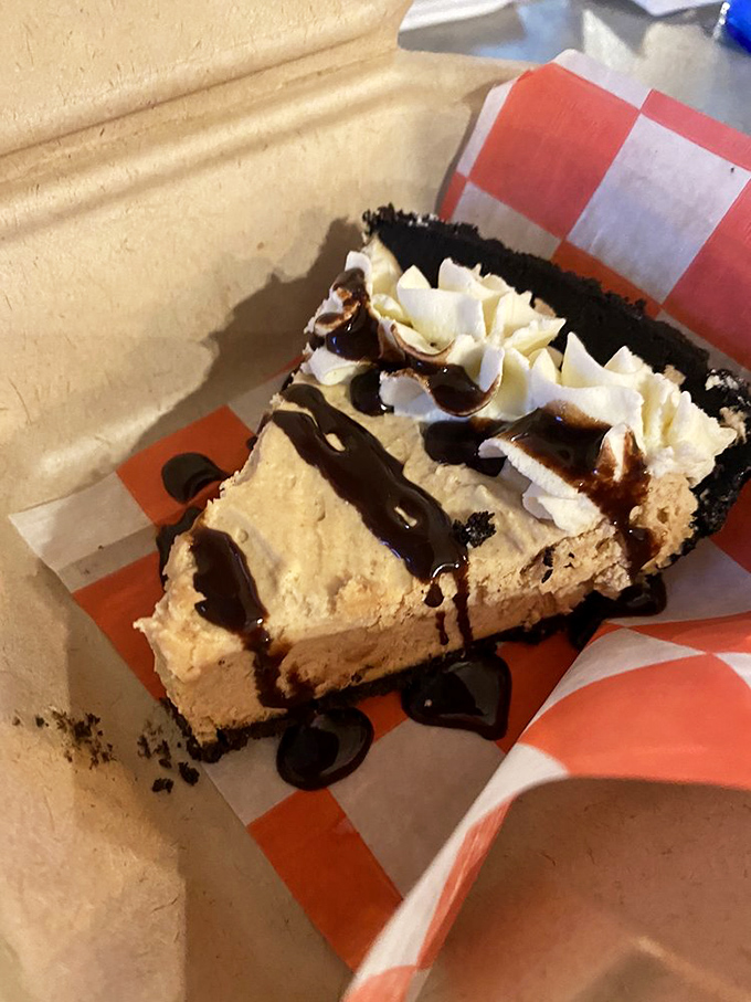 This isn't just dessert; it's therapy on a plate. Peanut butter pie with chocolate drizzle that makes you contemplate ordering a second slice before finishing the first.