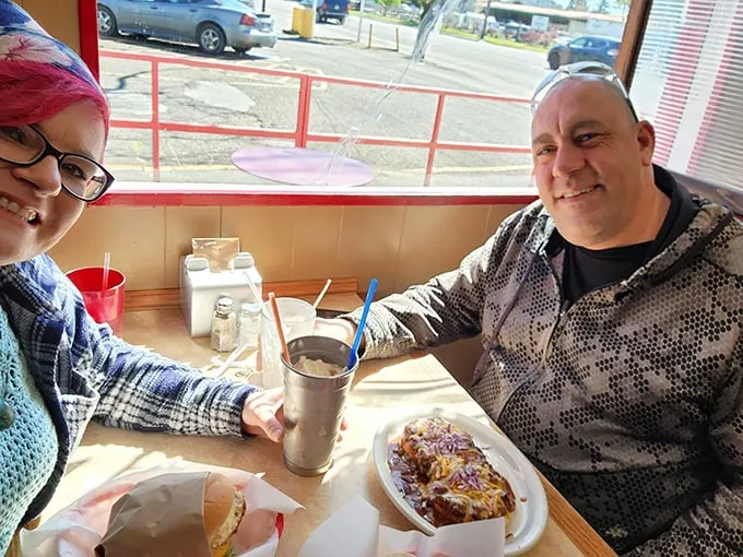 Happy diners, happy times! These folks look like they've discovered the secret to eternal burger joy.