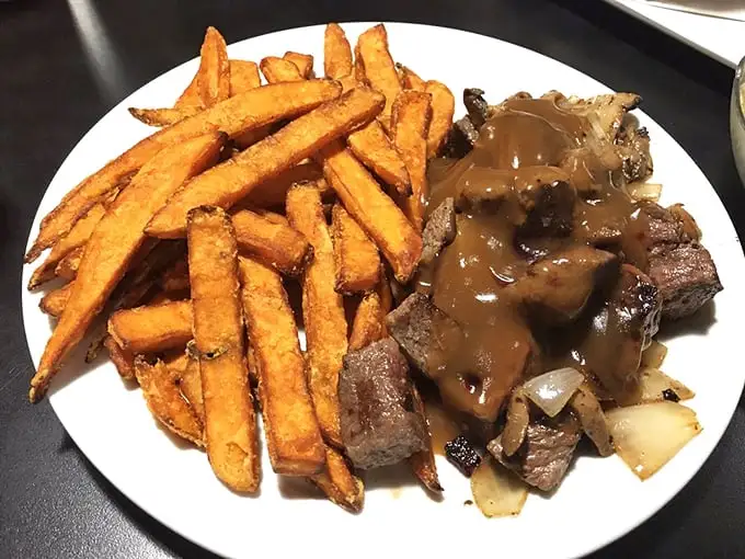 Steak and sweet potato fries – proof that diners do dinner just as well as breakfast. That gravy doesn't just cover the meat; it embraces it.