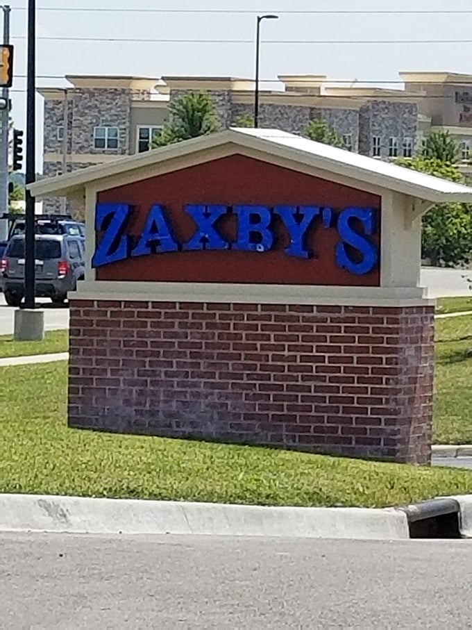 The bat-signal for hungry heroes! This sign stands tall, a beacon of hope for empty stomachs everywhere.