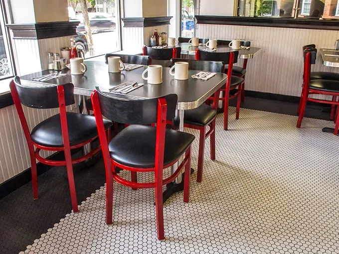 Tables set for culinary adventures. The red chairs stand ready, like boxing corners waiting for the next round of delicious battles.