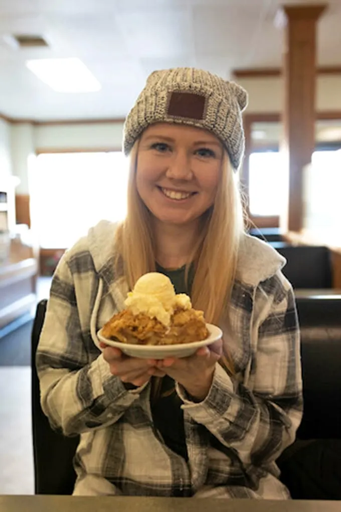 Happiness is a warm pie and a cold day. This diner's smile is brighter than the ice cream atop that slice of heaven.