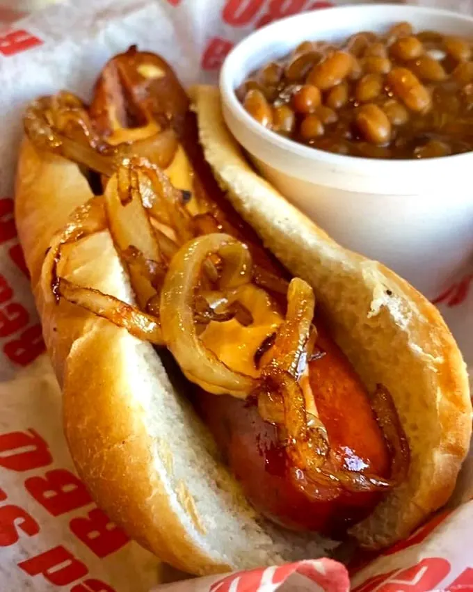 Not your average dog! This loaded hot dog is putting on the Ritz, dressed to the nines with enough toppings to make a salad bar jealous.