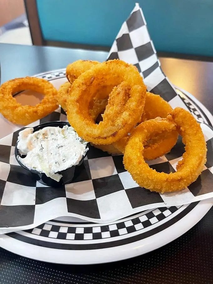 Onion rings that could double as edible jewelry. Crispy, golden, and perfectly seasoned – they're the supporting actors that often steal the show.