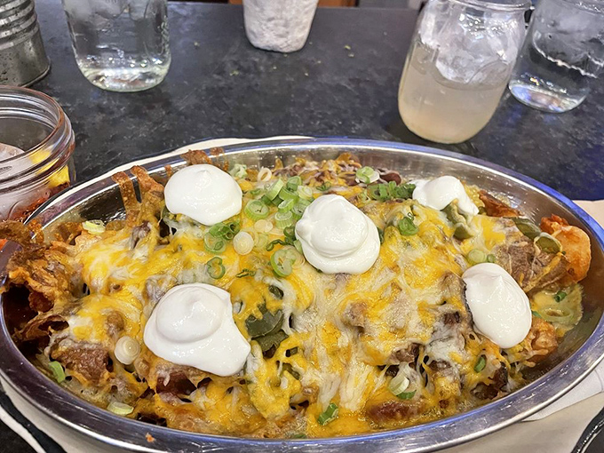 Not your average nachos – this mountain of melty cheese, pulled pork, and dollops of sour cream turns finger food into a full-contact sport.