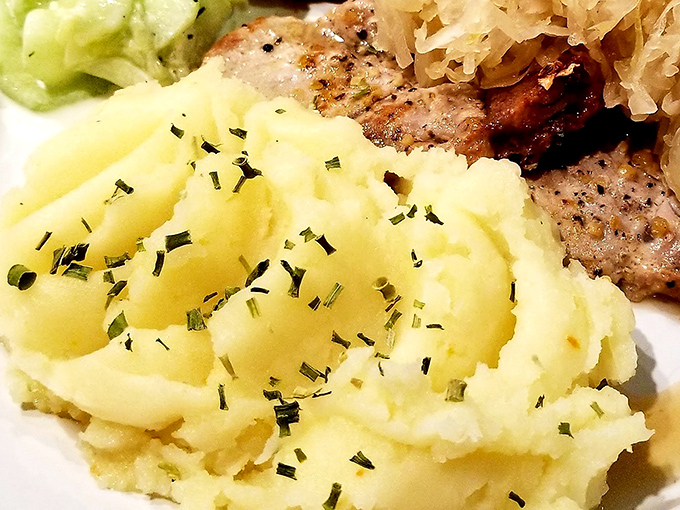 These mashed potatoes aren't just whipped—they're serenaded into submission. The perfect golden pool of butter creates a lake you'd happily swim in.