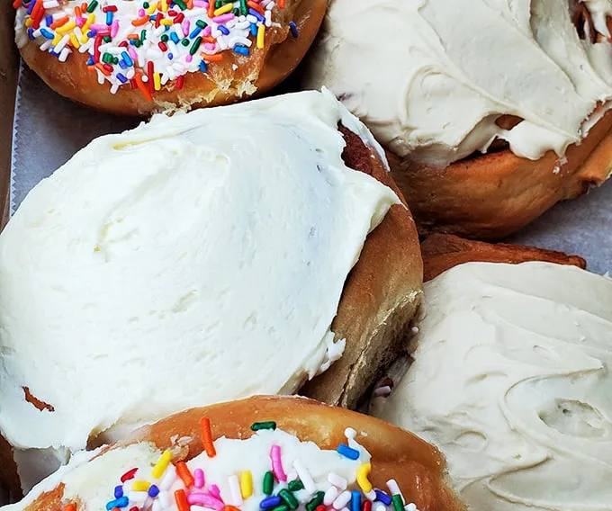A rainbow of deliciousness! These colorful donuts are like edible jewelry – who needs diamonds when you have sprinkles?