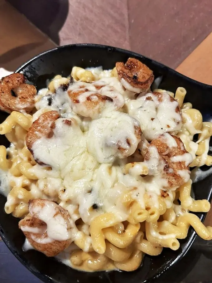 This skillet of mac and cheese with perfectly seared shrimp isn't just a side dish—it's the main event that will haunt your cheese-related dreams.
