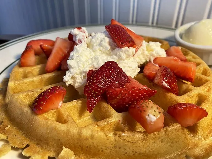 A waffle that's dressed for success. With those strawberries on top, it's like breakfast decided to put on its Sunday best.