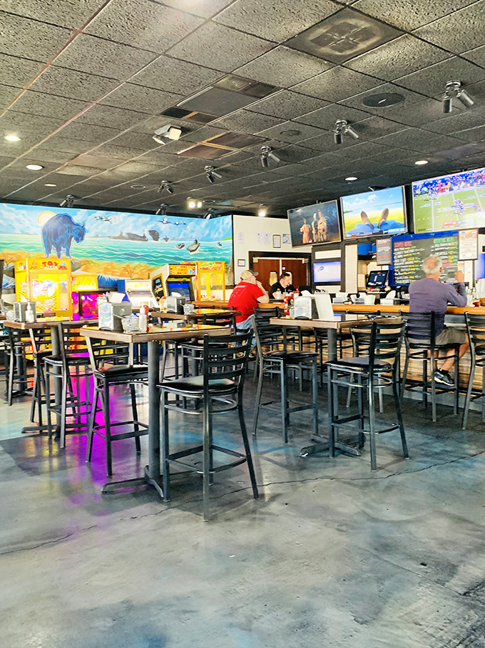 Where the magic happens—the bar area featuring buffalo murals and enough TVs to satisfy even the most dedicated sports multitasker.