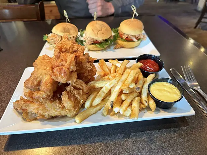 Sliders and tenders and fries, oh my! This plate is like a greatest hits album of pub grub – every bite's a chart-topper.