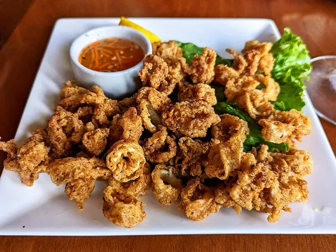 Crispy, golden, and utterly irresistible! This Thai-seasoned calamari is like the potato chip of the sea – bet you can't eat just one piece!