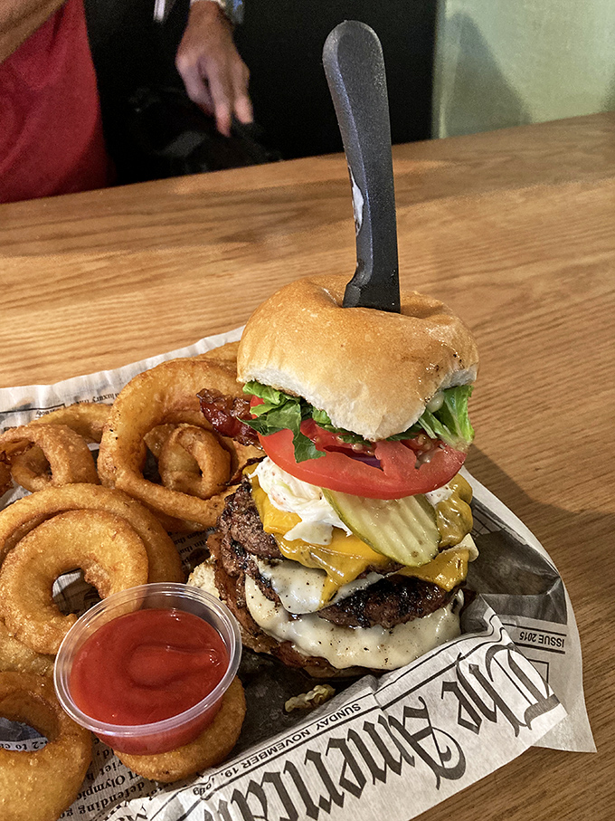 Holy cow! This burger isn't just stacked; it's a towering inferno of flavor that'll have you planning your next visit before the last bite.