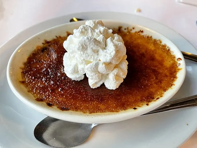Crème brûlée so perfectly torched, it could moonlight as a welder. Crack that sugar and dive in!