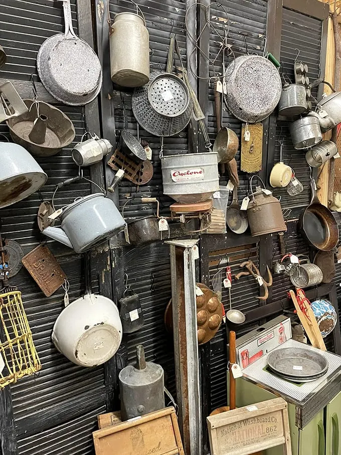 The wall of vintage kitchenware—where your grandmother's potato masher hangs alongside tools modern cooks can't even identify.