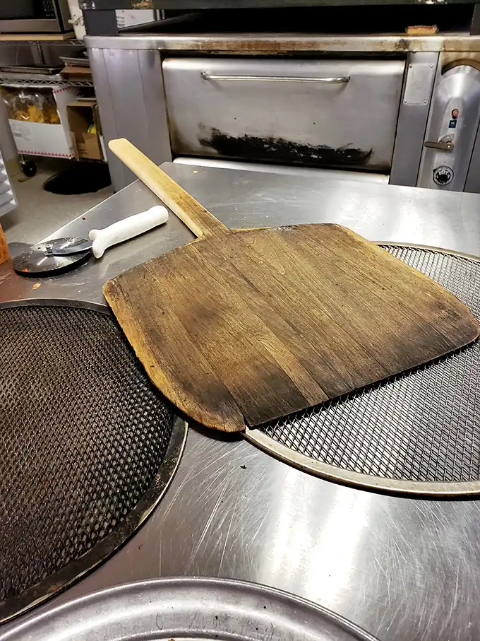 Where the magic happens! Rosa's kitchen might not be fancy, but it's got all the right ingredients for pizza perfection – including that well-seasoned pizza peel.