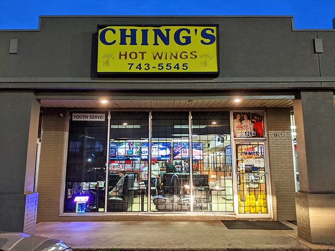 As night falls, that yellow sign glows like a lighthouse, guiding hungry souls to their wing salvation. Memphis magic at its finest.