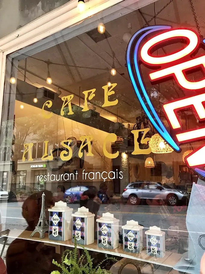 That neon sign isn't just advertising; it's a beacon of hope for empty stomachs and Francophiles alike.