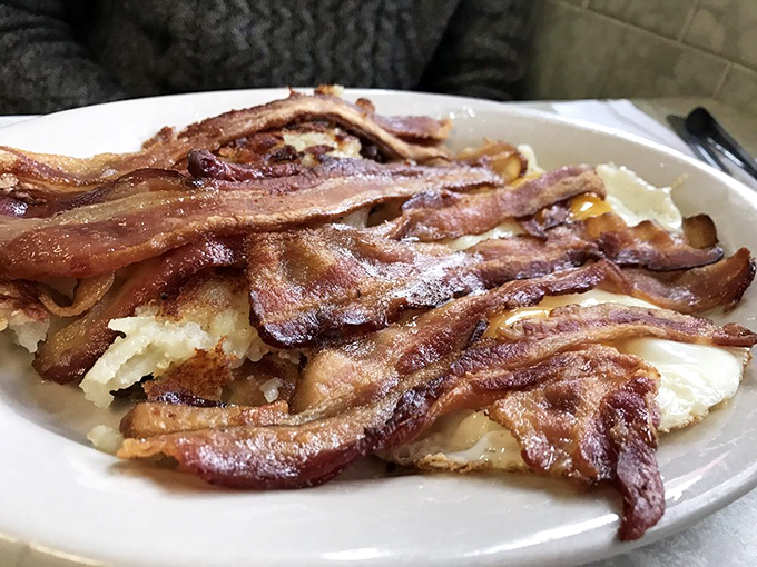 Bacon arranged like a work of abstract art – crispy, glistening, and making a compelling argument that everything else on the plate is merely a supporting actor.