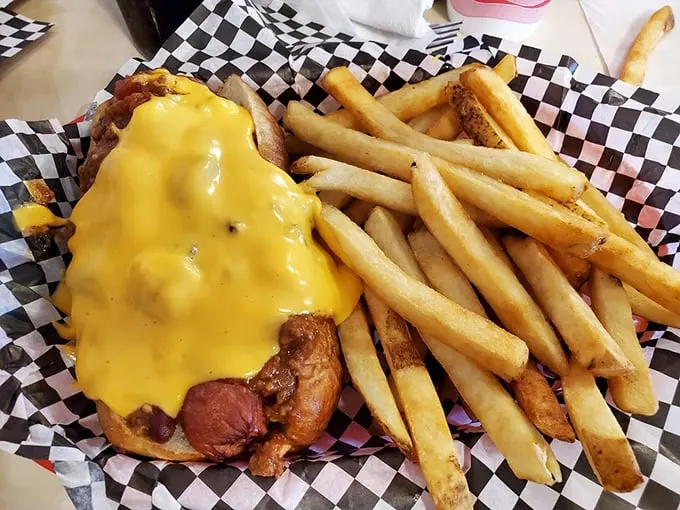 Hot diggity dog! This chili cheese masterpiece is what happens when comfort food gets a PhD. It's messy, it's delicious, it's the American dream on a bun.