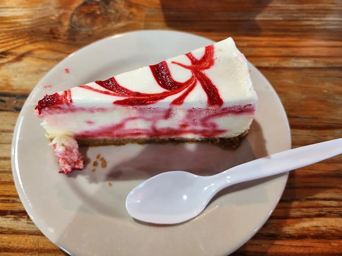 A slice of raspberry swirl cheesecake that somehow manages to be both light and decadent—the dessert equivalent of having your cake and eating it too.