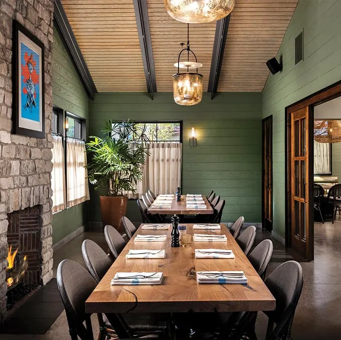 Step into a seafood lover's dream! This dining room's green walls and warm wood tones create an atmosphere as inviting as a mermaid's siren song.