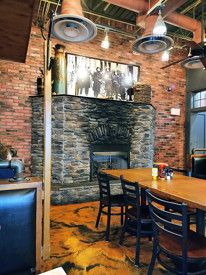 That stone fireplace isn't just for show—it's the soul of the restaurant, surrounded by exposed brick walls that whisper "stay awhile."