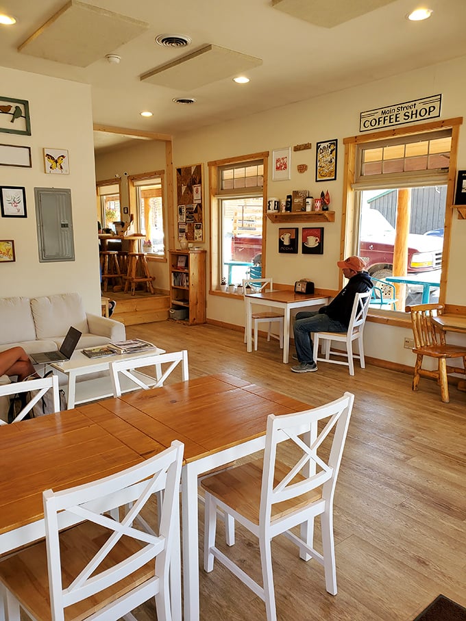 Cozy up in this home-away-from-home! The Cowboy Cafe's interior is like a warm hug, with its inviting wooden accents and eclectic wall art.