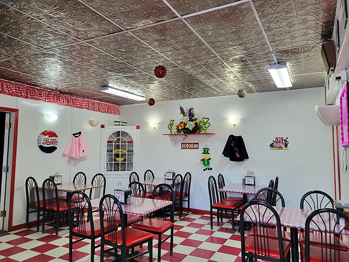 Inside, it's a retro wonderland! The black-and-white floor practically begs you to do the twist. Just don't spill your shake – these tiles have seen enough excitement!