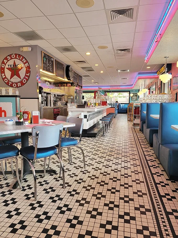 Step inside and time travel to America's golden age of roadside dining—checkerboard floors, blue vinyl booths, and neon lighting that makes everyone look 10% more attractive.