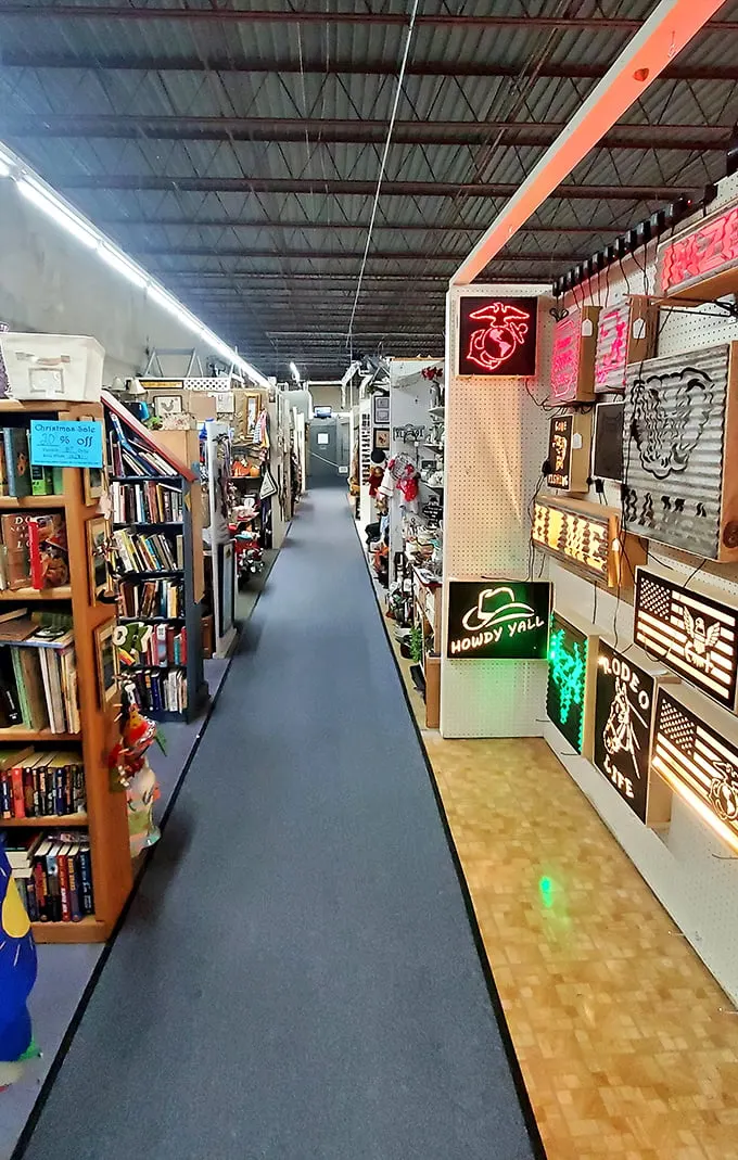 Neon dreams and literary treasures line these aisles. That "Howdy Y'all" sign isn't just decoration—it's practically the Arkansas state greeting.