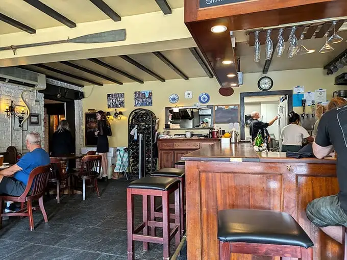 Where exposed beams tell stories and the polished wood bar has absorbed decades of laughter, toasts, and satisfied sighs.