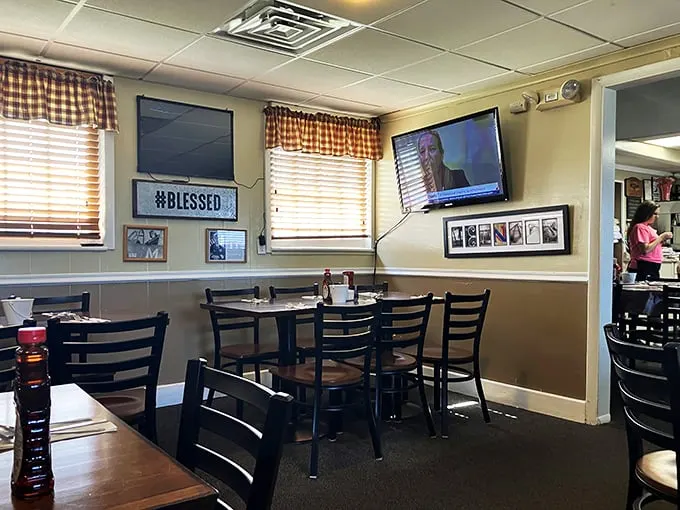 Cozy vibes and checkered curtains? Check! This diner's interior is like a warm hug from your favorite aunt – if she were really into planes.