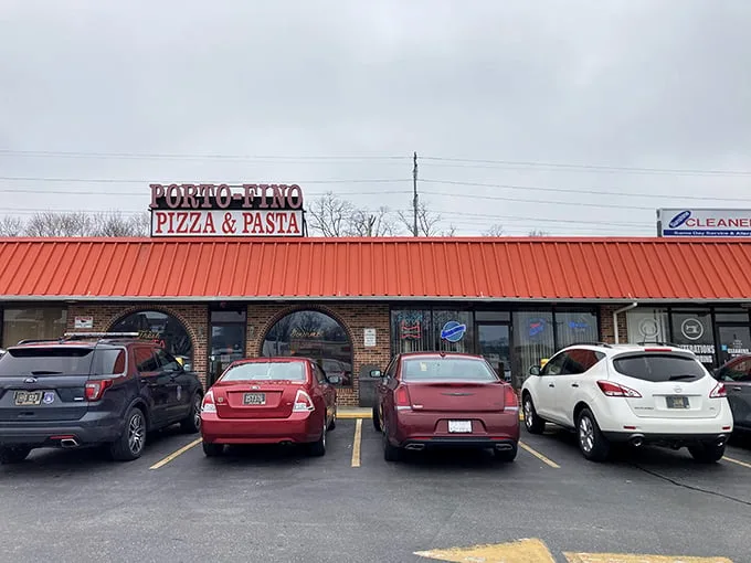 Porto-Fino's unassuming strip mall presence is the culinary equivalent of Clark Kent—ordinary exterior, superhero-level pizza inside.