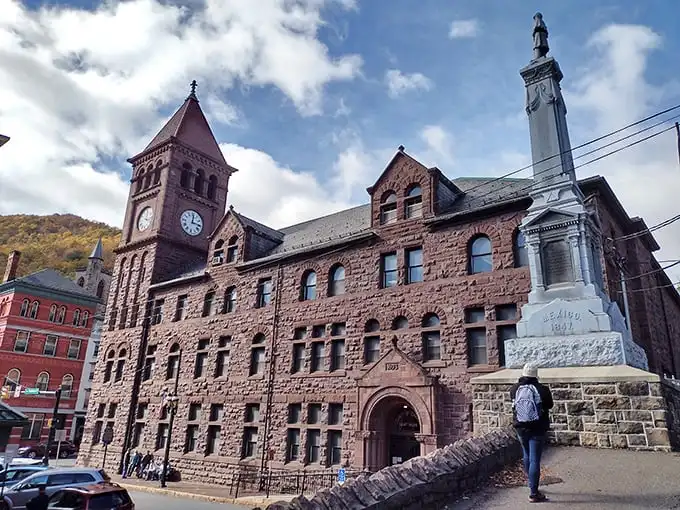 The Carbon County Courthouse stands like a Victorian sentinel, its clock tower keeping watch over a town where history isn't just remembered—it's lived daily.